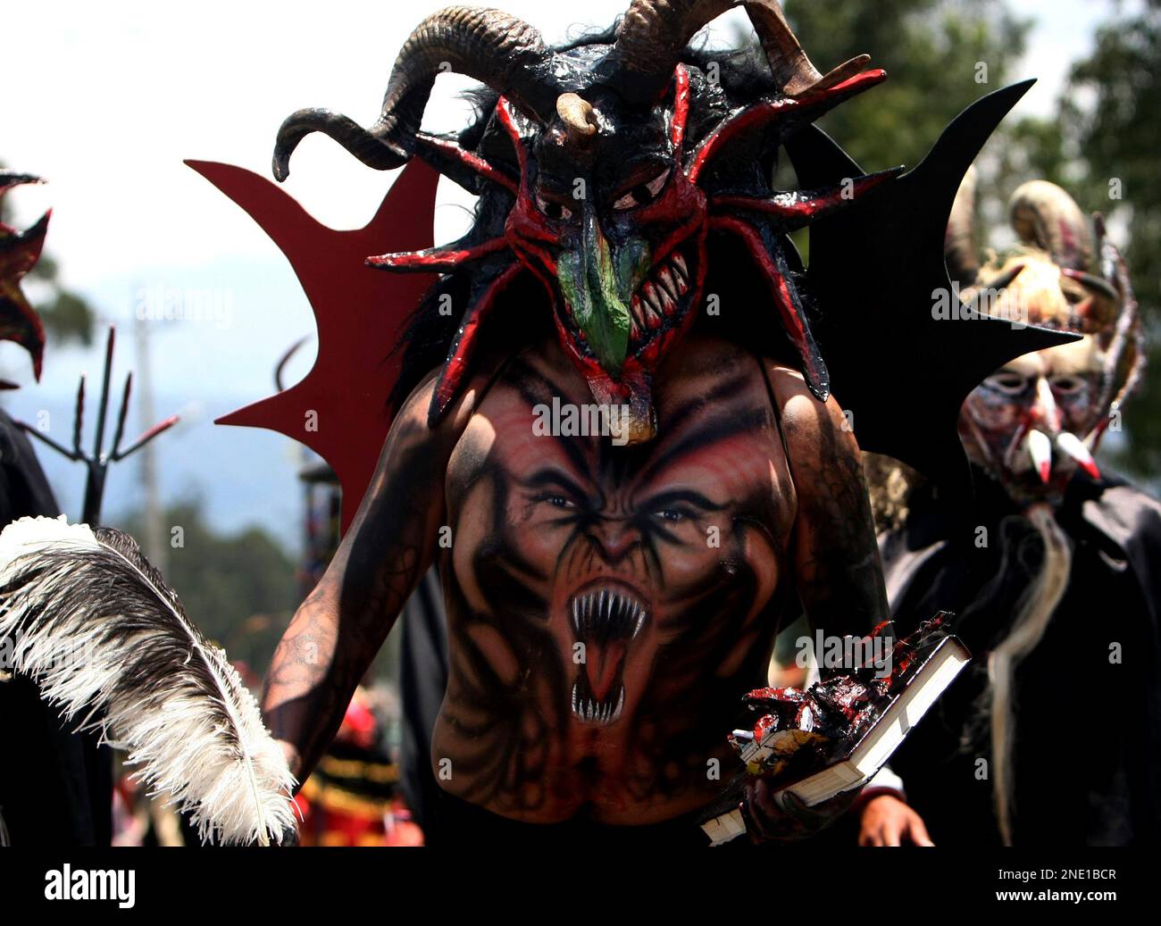A man dressed as a devil participates in a Holy Week procession on Good ...