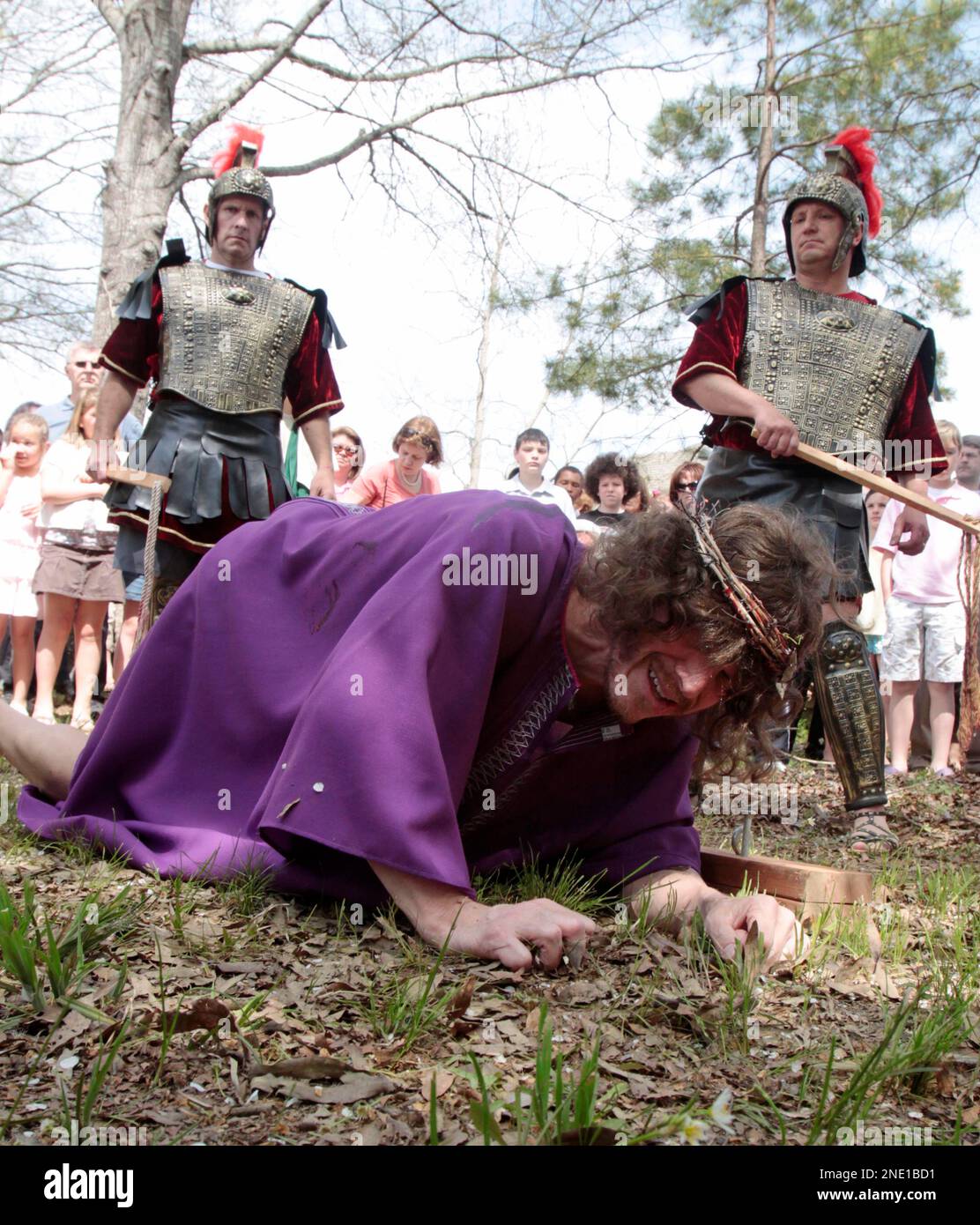 Jesus, played by Keith Comish, grimaces as he falls for the second time ...