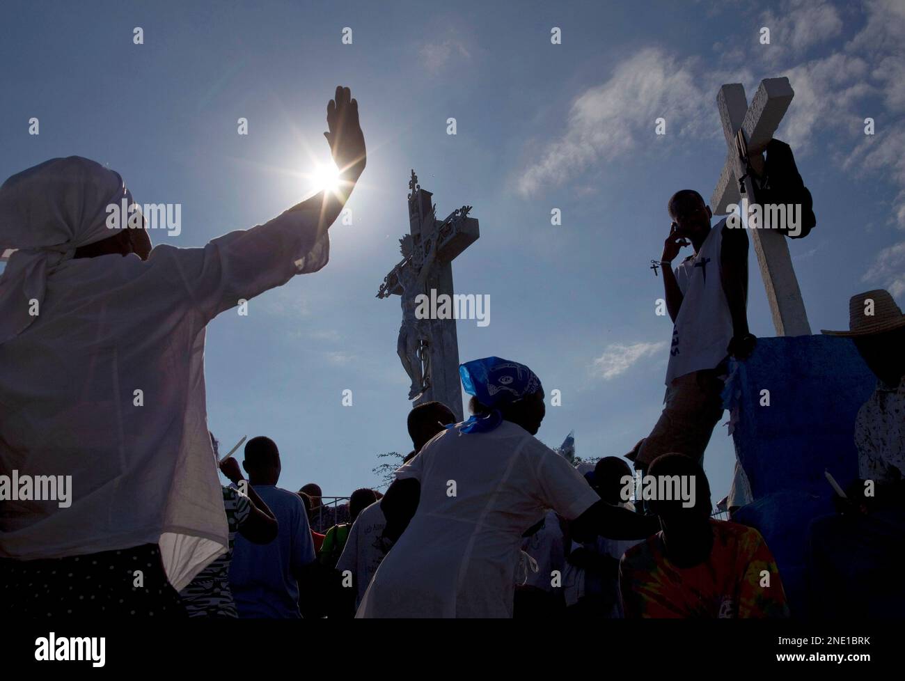 People gestures in front of crosses during a Holy Week procession in ...