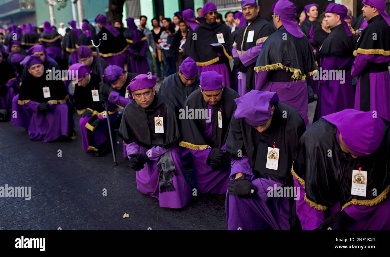 Penitents take part in a Holy Week procession in Guatemala City, Friday ...