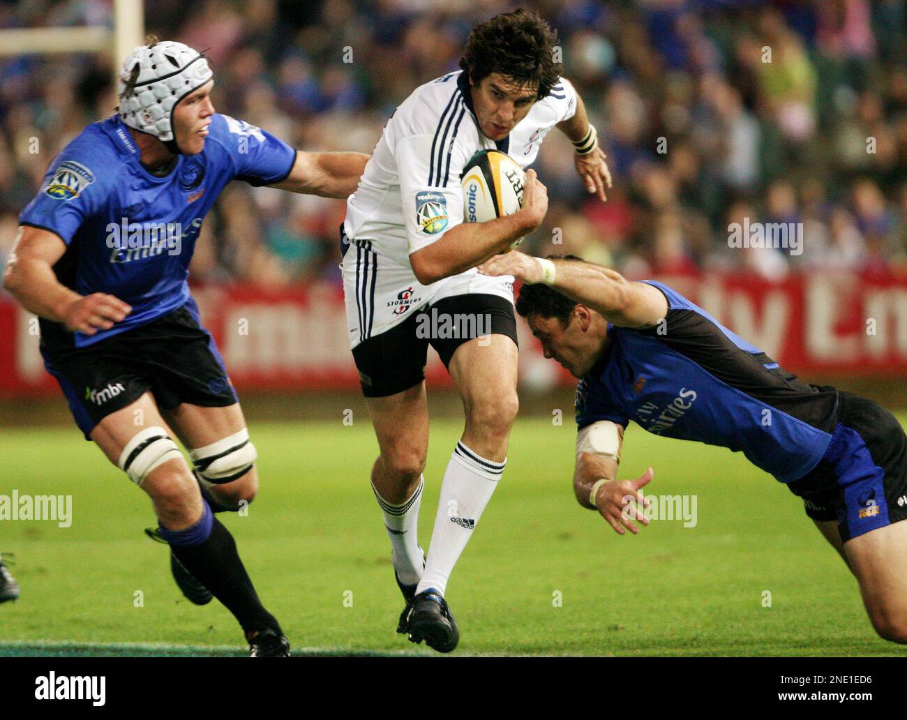 Jaque Fourie of South Africa's Stormers, center, gets past Australia's ...