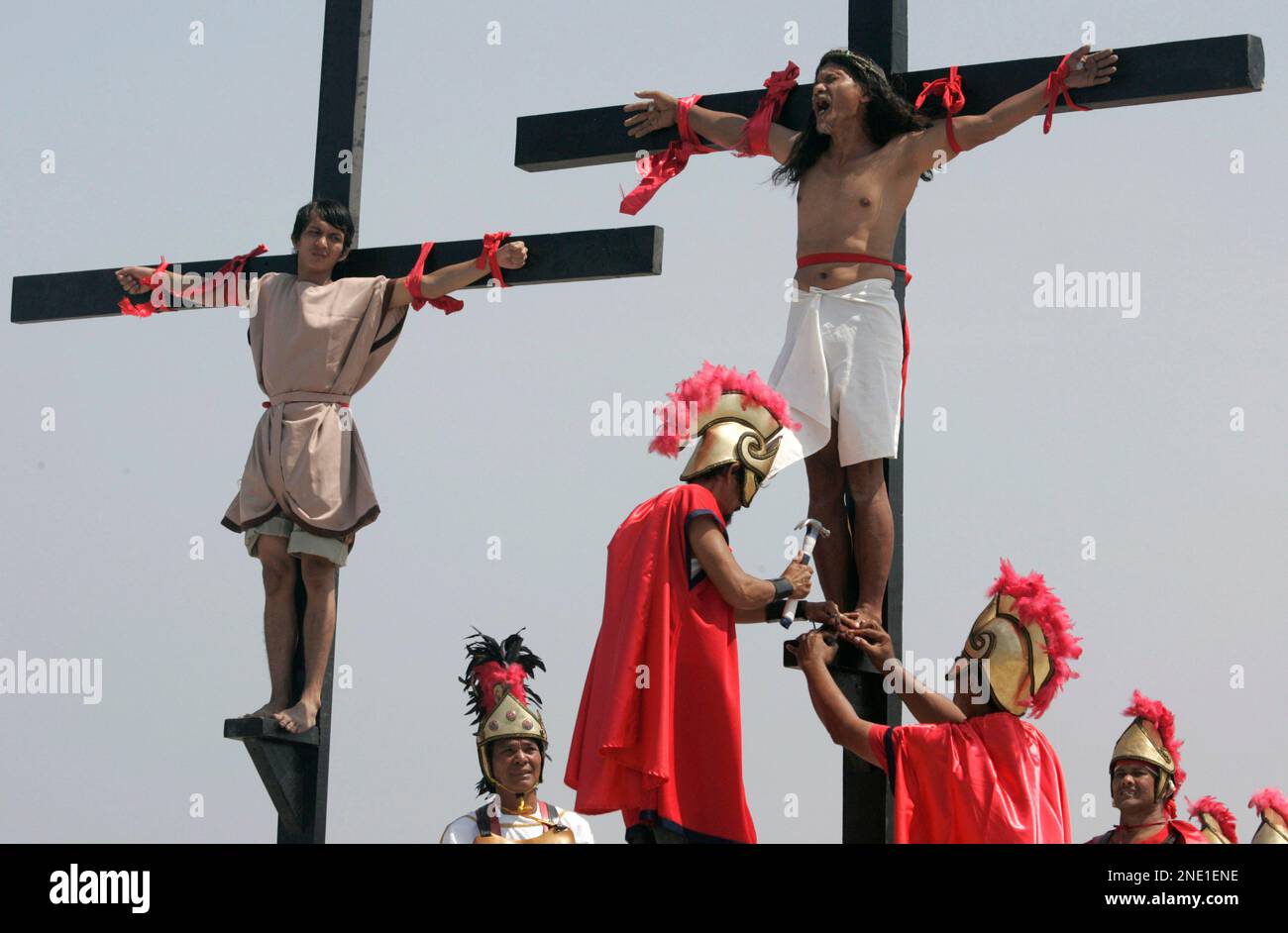 Ruben Enaje, right, who has been nailed to the cross for 24 times ...