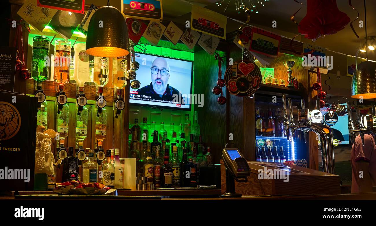 Drinks and TV screen behind the bar in an English pub Stock Photo - Alamy