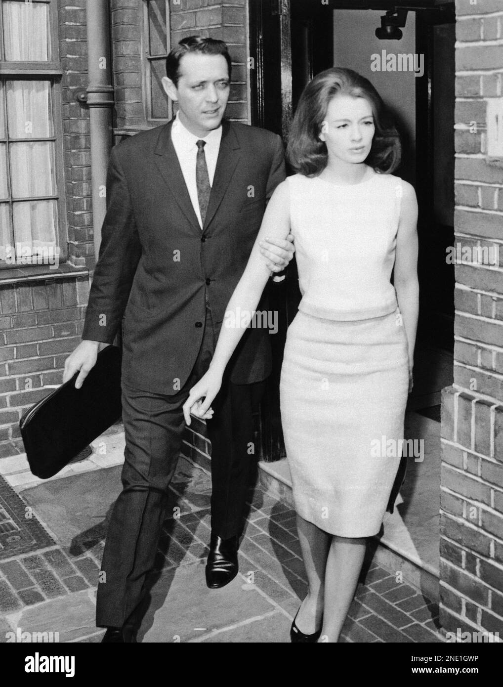 Christine Keeler, 22, is escorted from her London residence on June 7 ...