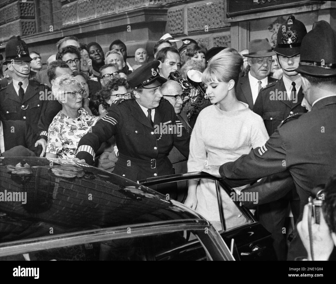 Police escort Marilyn (?Mandy?) Rice-Davies a witness in the trial of ...
