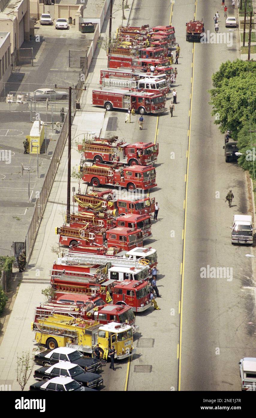 Los Angeles Fire Department trucks line up in a staging area near 109th ...