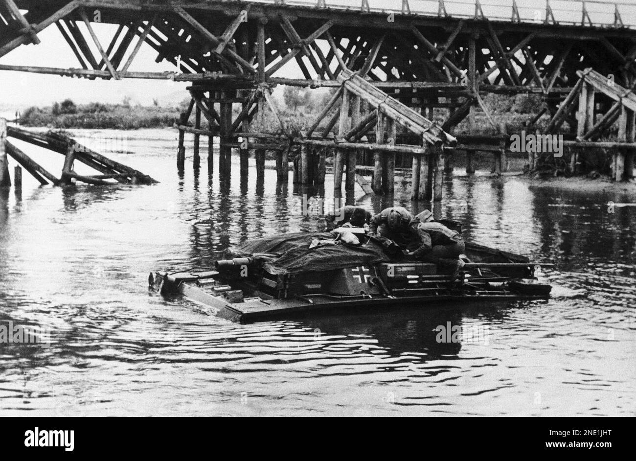 German soldiers check a tank while crossing the river between the ...