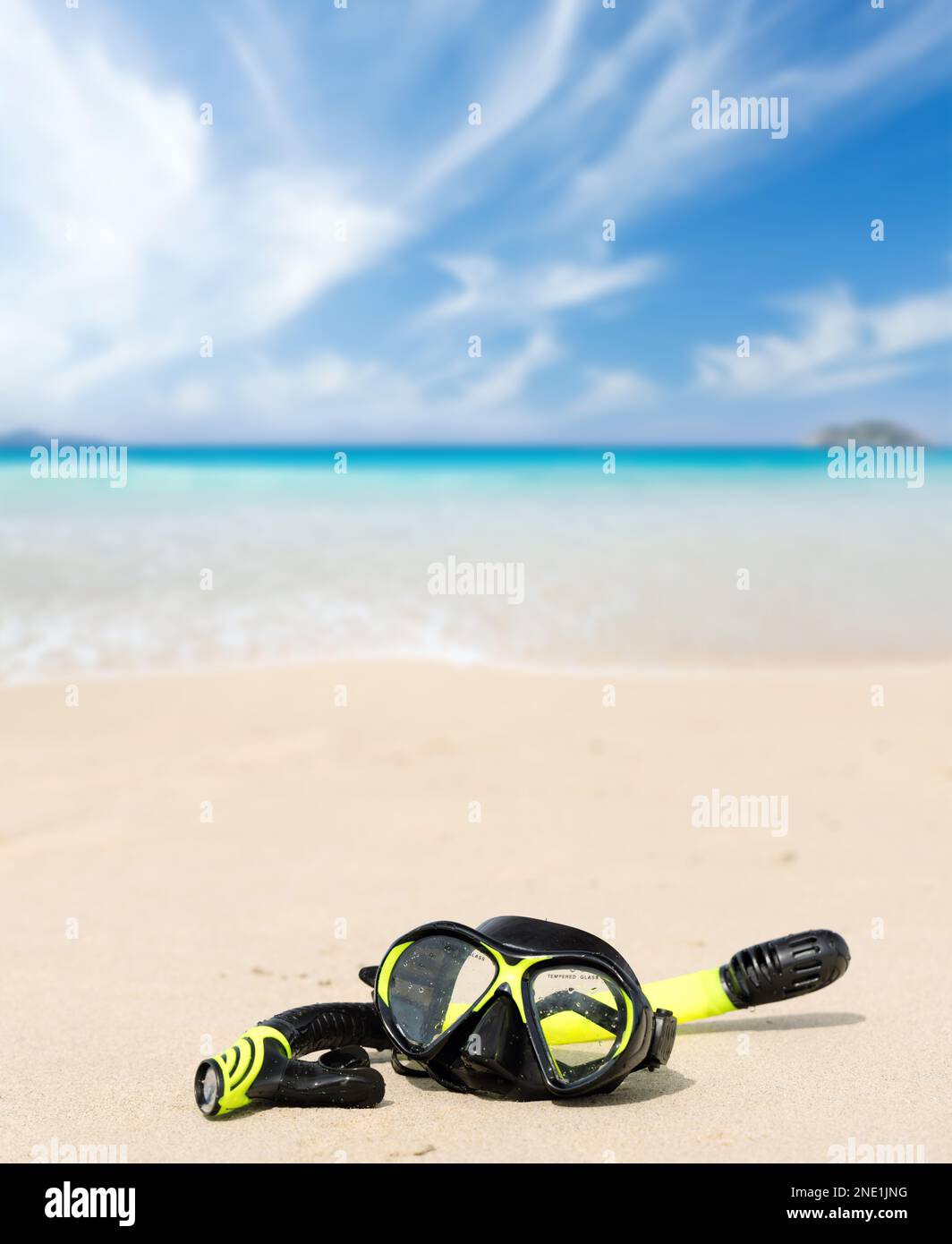 Snorkeling mask on sand beach in front of sunny sea landscape. Summer ...
