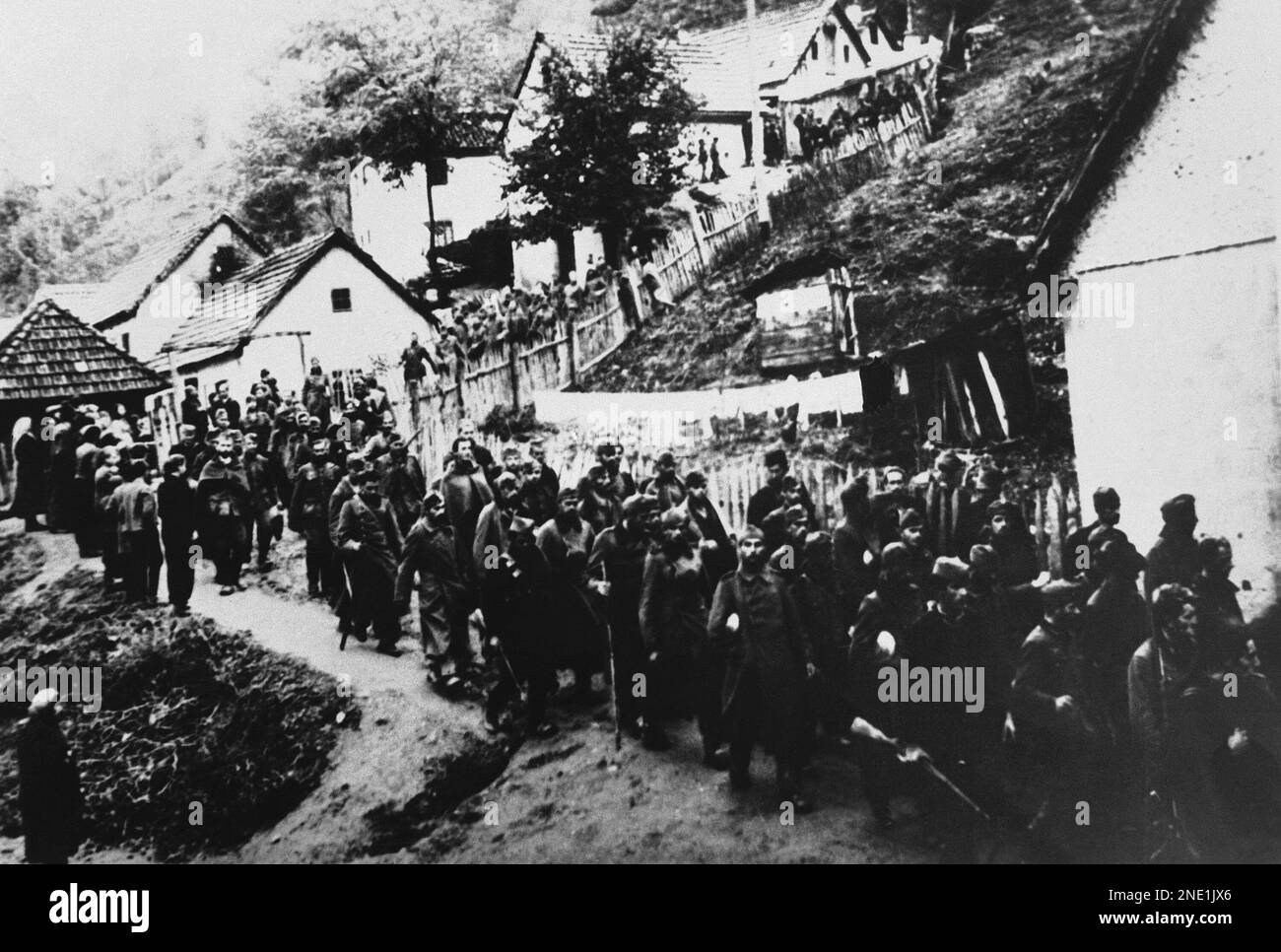 A column of German prisoners of war being marched away to internment ...