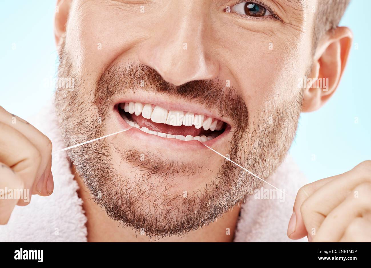 Dental care, health and man flossing teeth in studio for oral wellness or tooth grooming ...