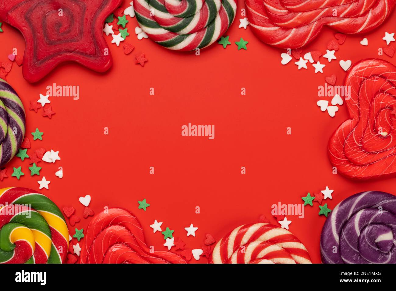 Various candy sweets and lollipops on red background and copy space for ...