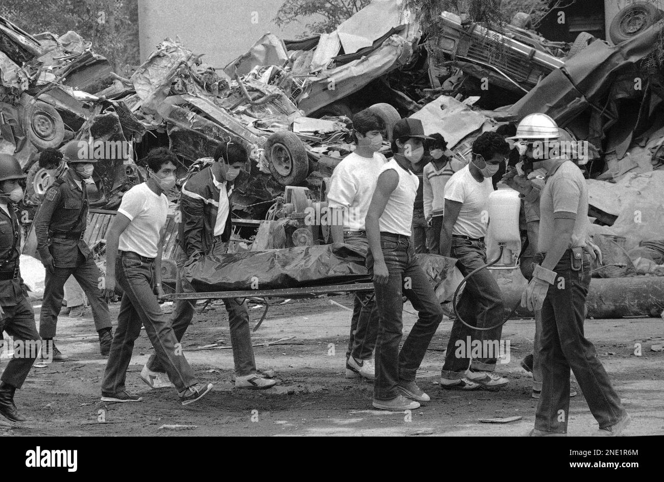 Workers carry the body of a relative of singer Placido Domingo from the ...