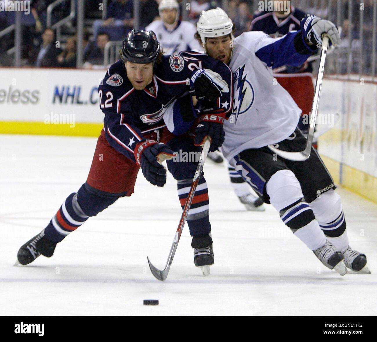 Columbus Blue Jackets' Mike Commodore, left, and Tampa Bay Lightning's ...