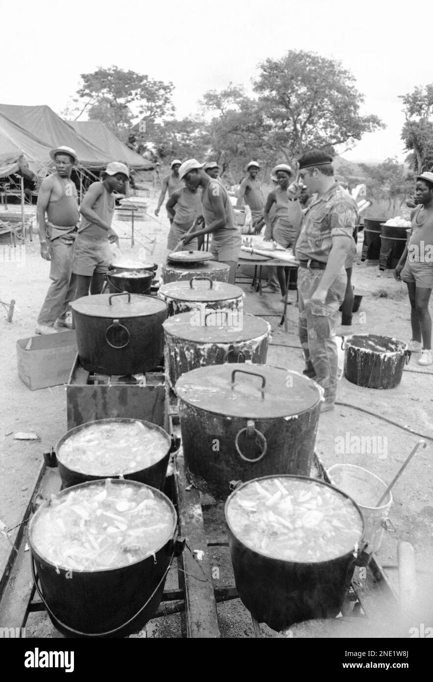 Guerrilla who joined the new units Rhodesian army peels potatoes while ...