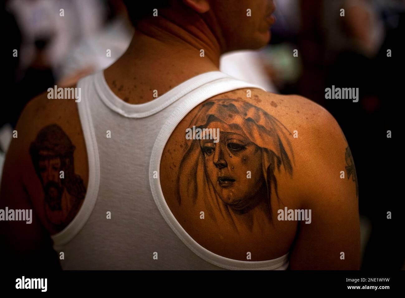 A tattoo of the Virgin Mary is seen on the back of a costalero, who ...