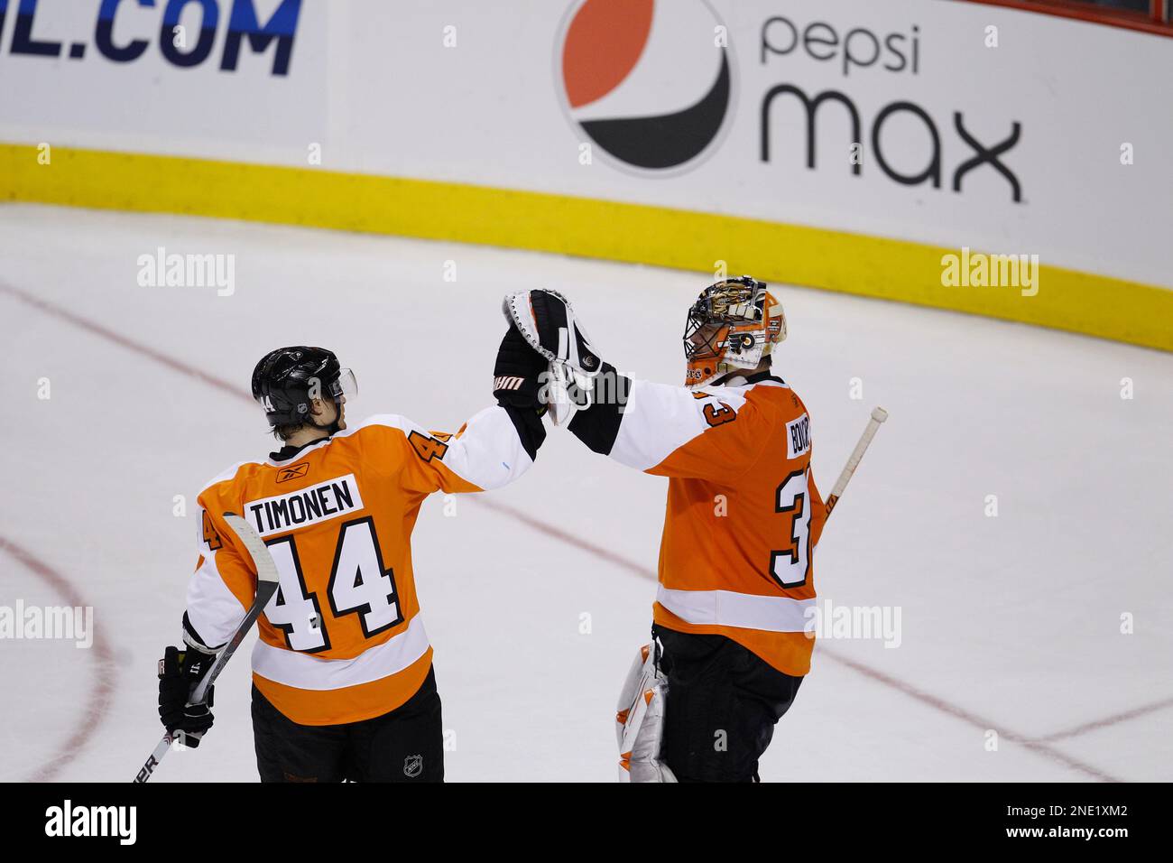 Philadelphia Flyers' Kimmo Timonen left, of Finland, and Brian Boucher ...