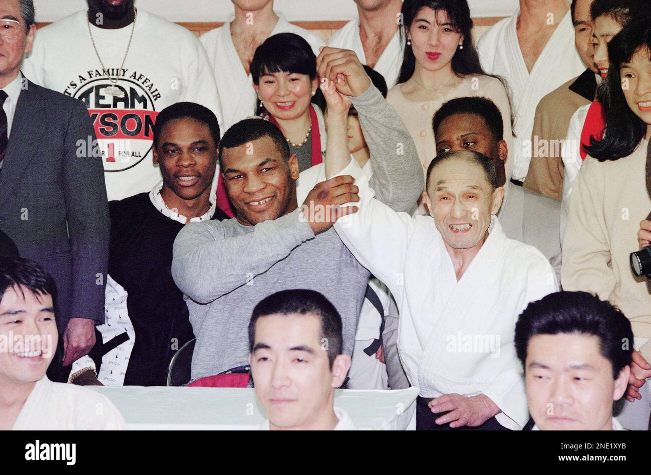 Heavyweight boxing champion Mike Tyson, left, raises the arm of Gozo ...