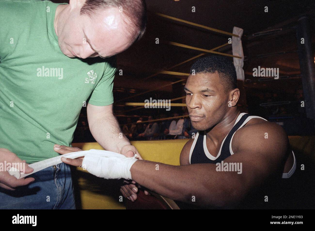 Heavyweight boxer Mike Tyson has his hand wrapped by trainer Kevin ...