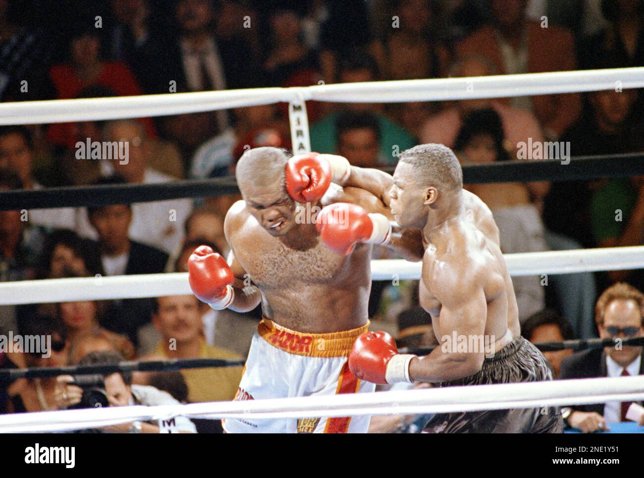 Mike Tyson lands a right to the head of Razor Ruddock during their ...
