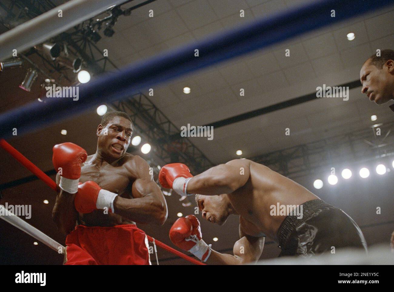 Heavyweight champion Mike Tyson ducks punch by challenger Frank bruno ...