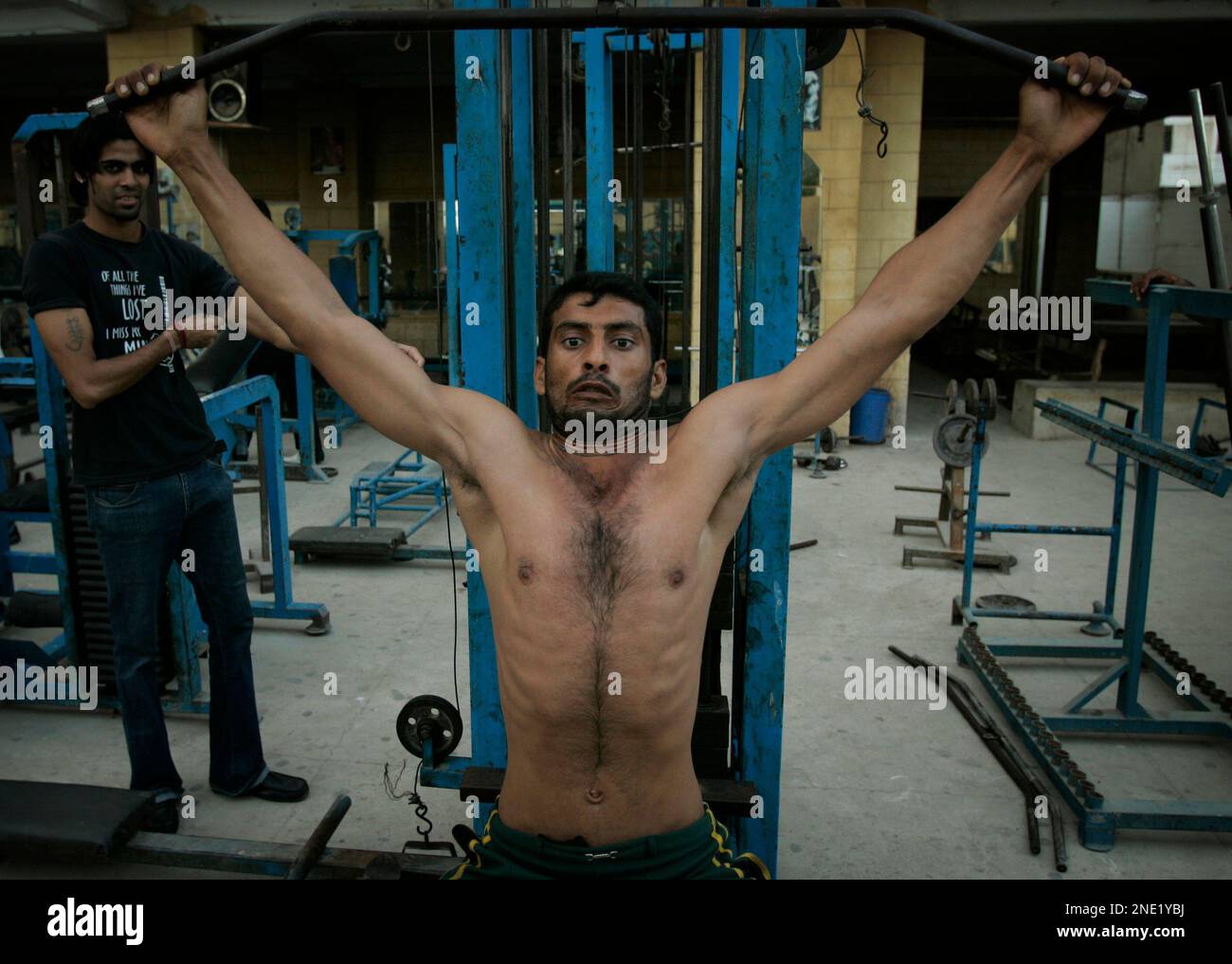 A Pakistani body builder works out at a local gym in Karachi, Pakistan ...