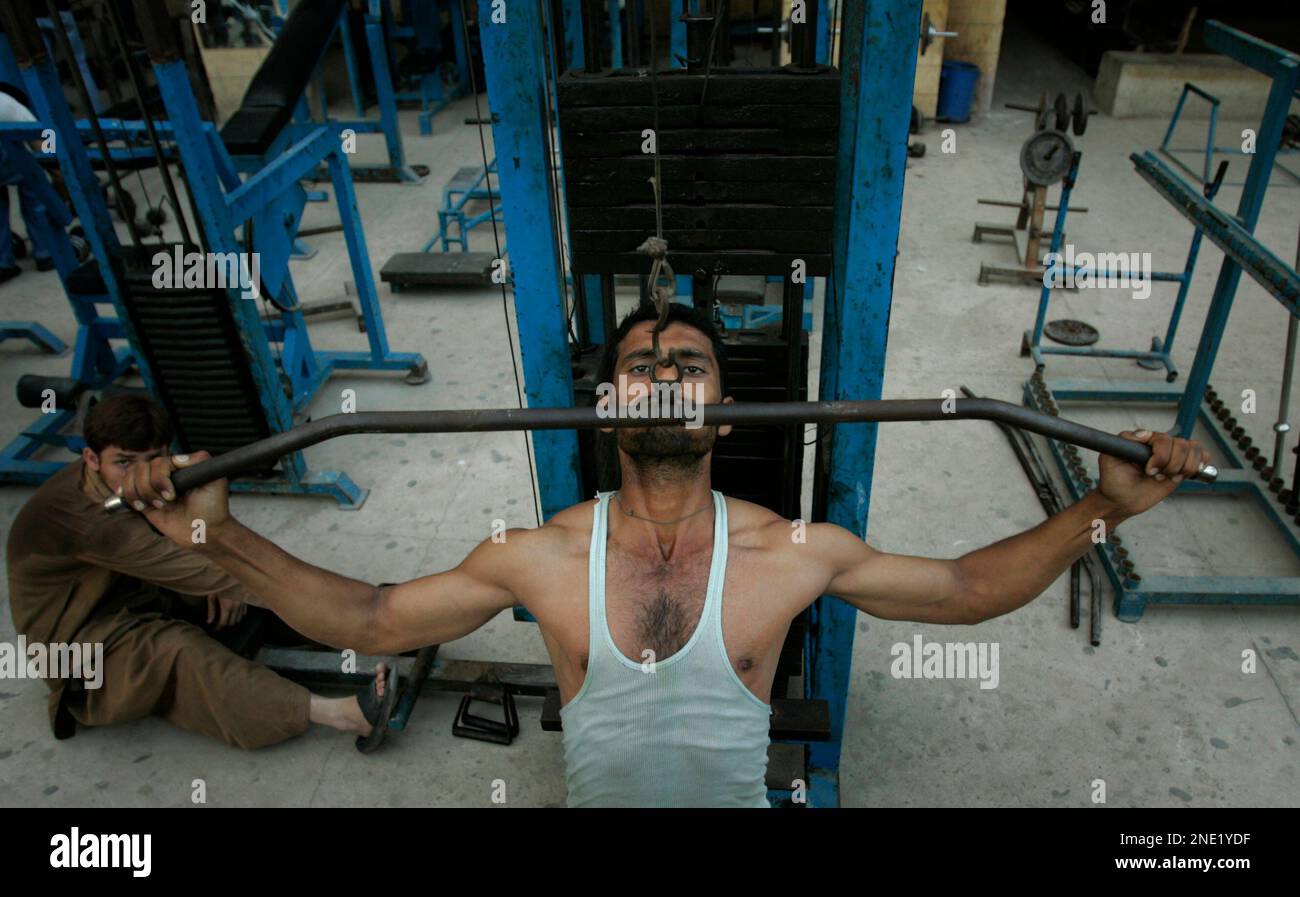 A Pakistani body builder works out at a local gym in Karachi, Pakistan ...