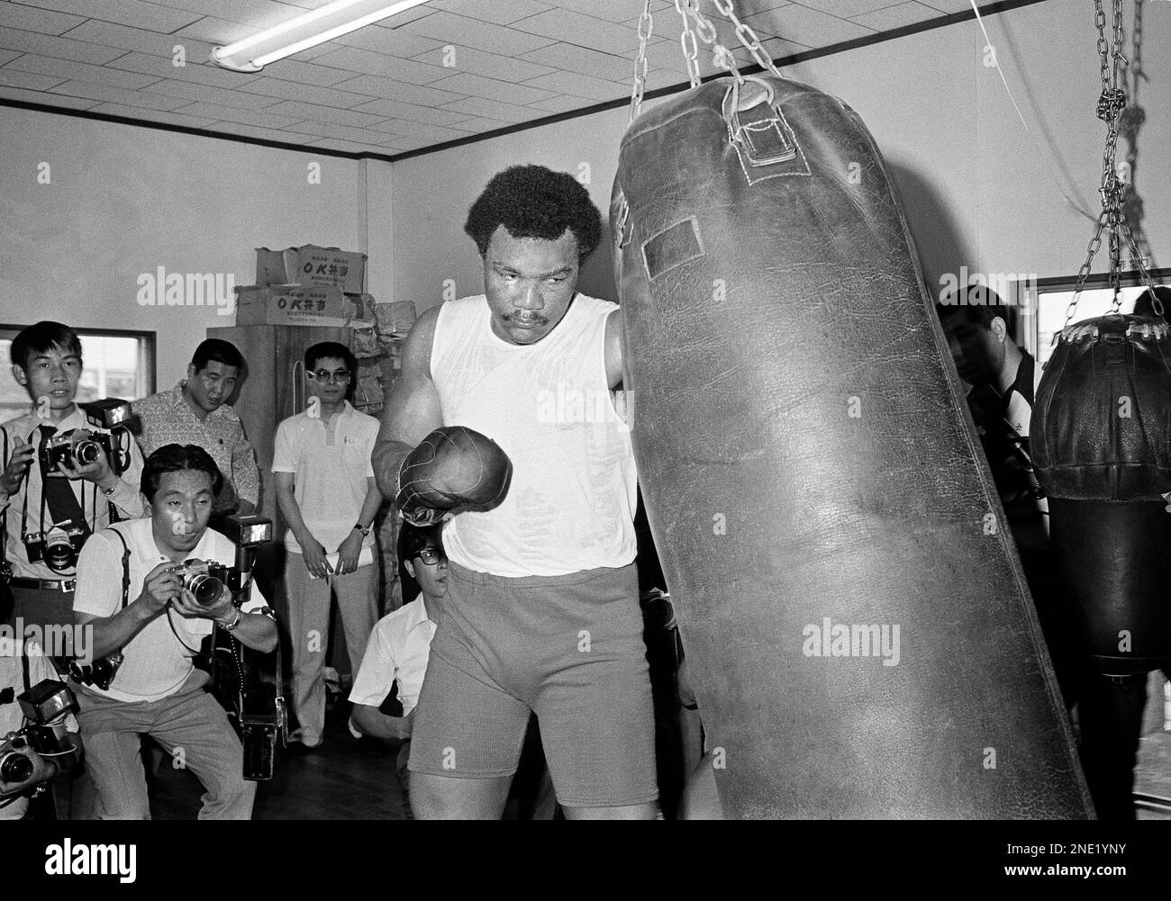 Photographers watch as World Heavyweight Champion George Foreman ...