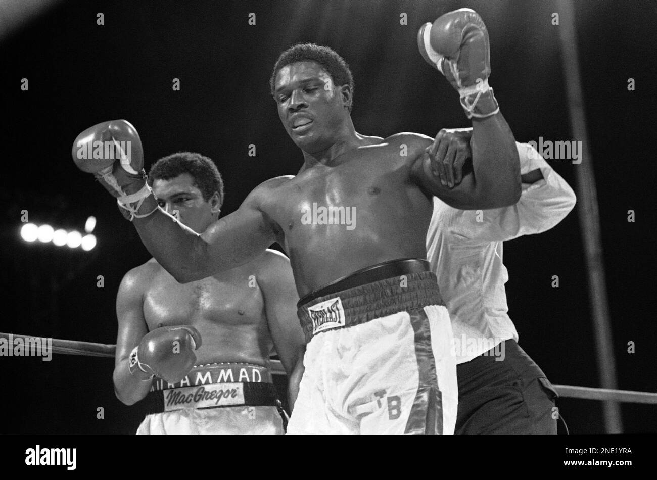 Trevor Berbick raises his arms as he hopes for victory as the 10th round ended with his fight ...
