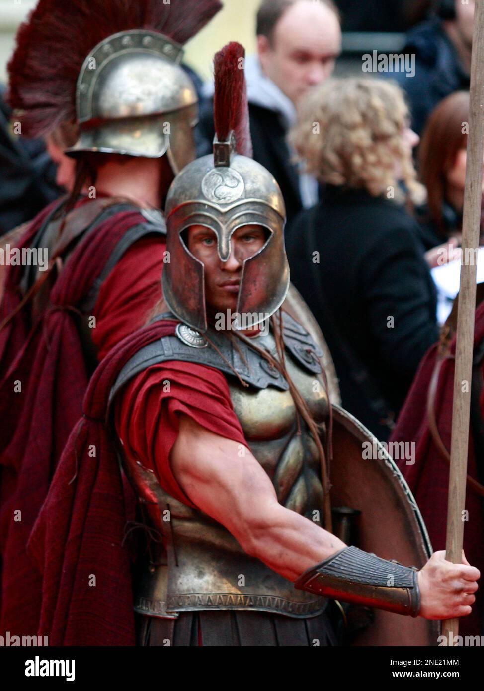 A model dressed as ancient Greek warriors poses for the photographers ...