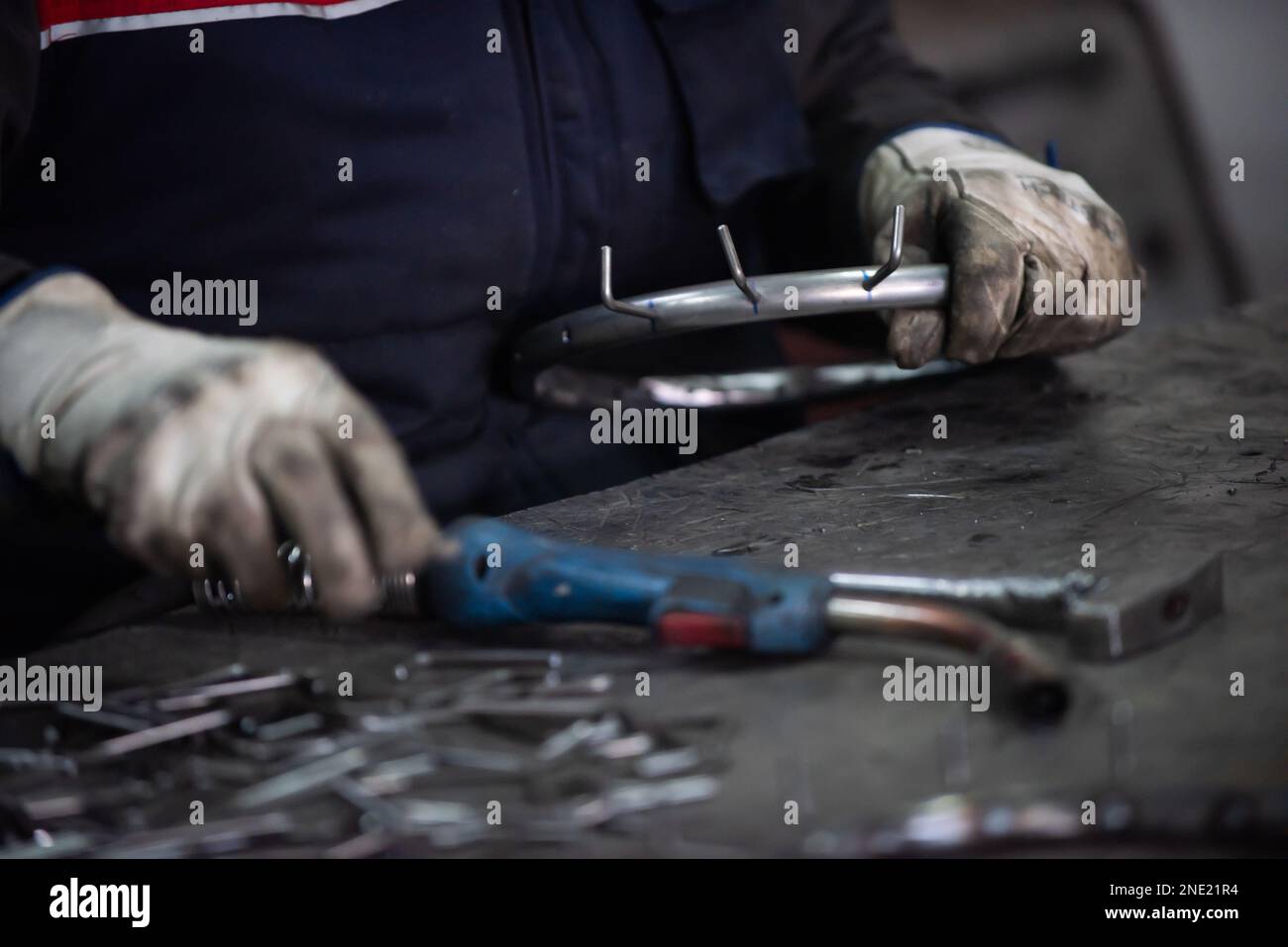A worker in an industry preparing iron structures for welding Stock ...