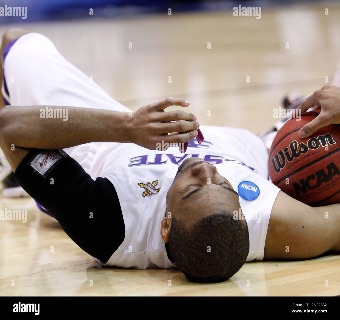 Kansas State's Chris Merriewether lies on the court during the first ...