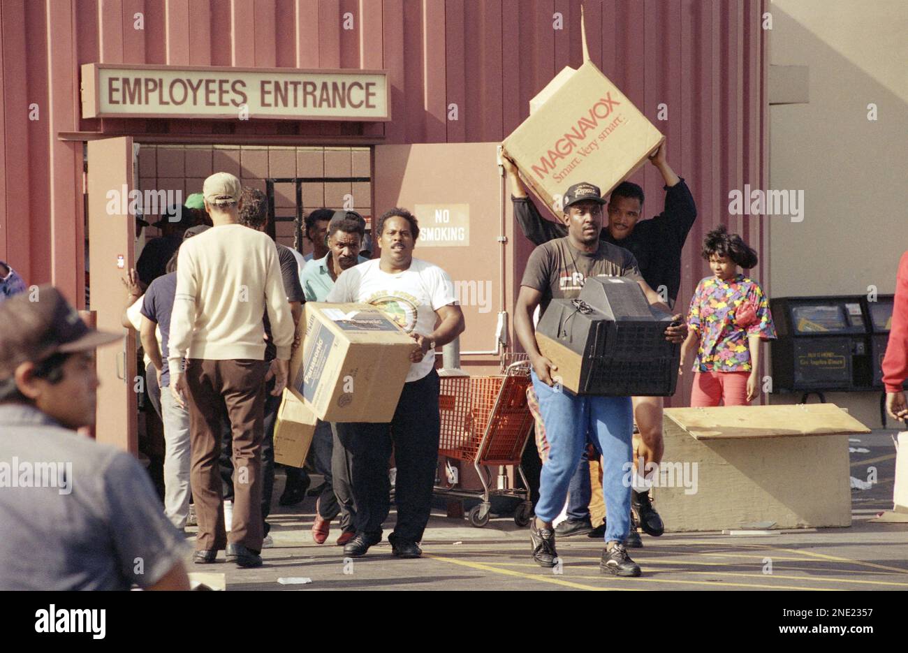 Looters carry televisions out of a Fedco Department Store at La Cienega ...