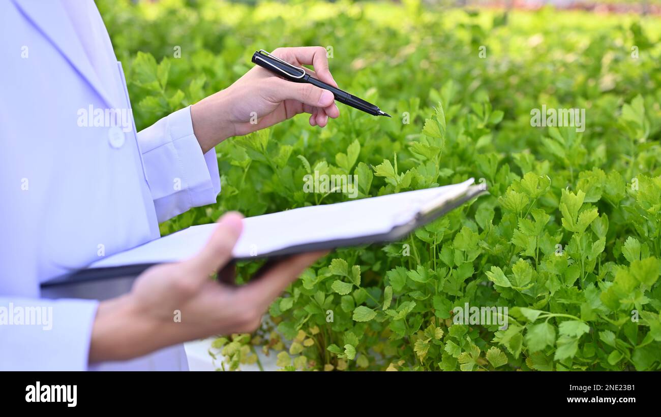 A professional female agricultural scientist or biologist in white gown ...