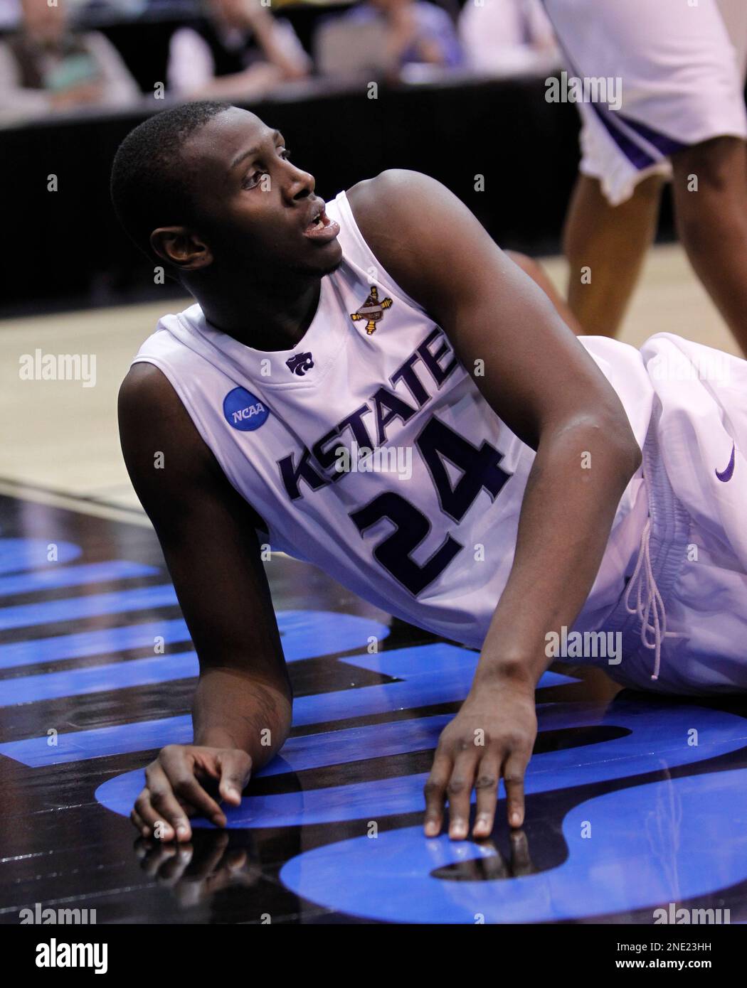Kansas State's Curtis Kelly lies on the court in the second half of an ...