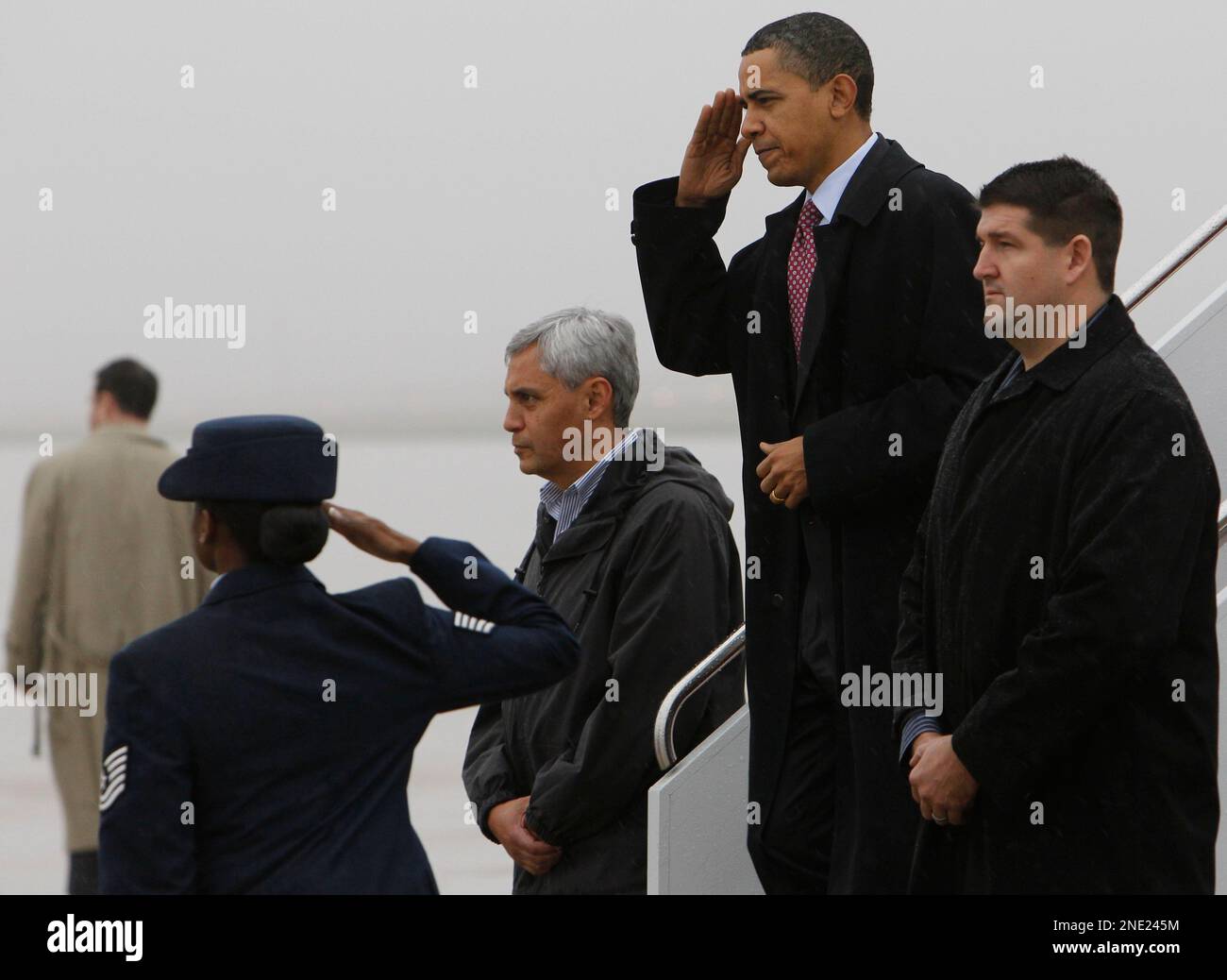 President Barack Obama returns a salute as he steps off Air Force One ...