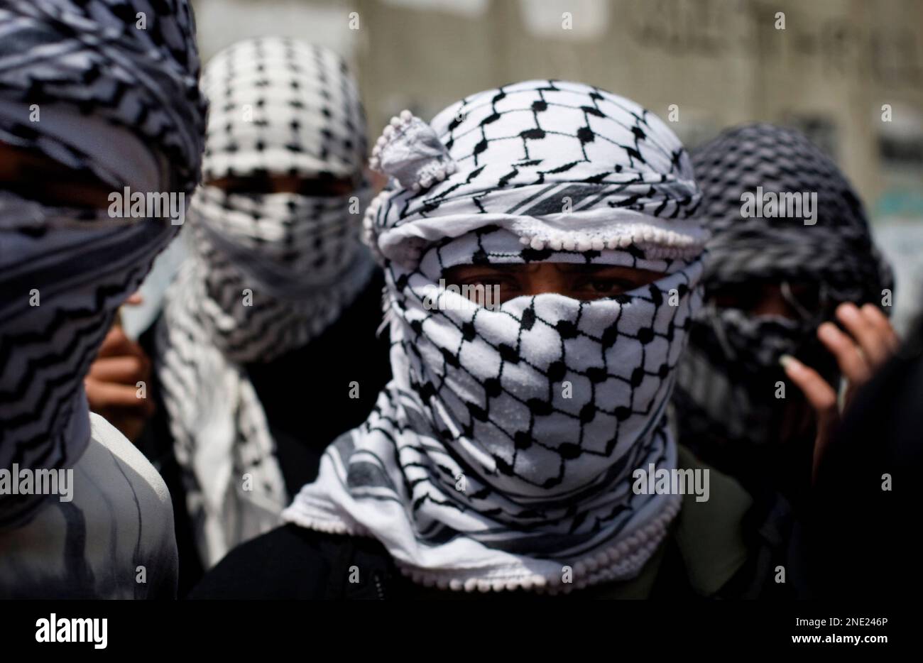 Masked Palestinian demonstrators are seen during a protest in the West ...