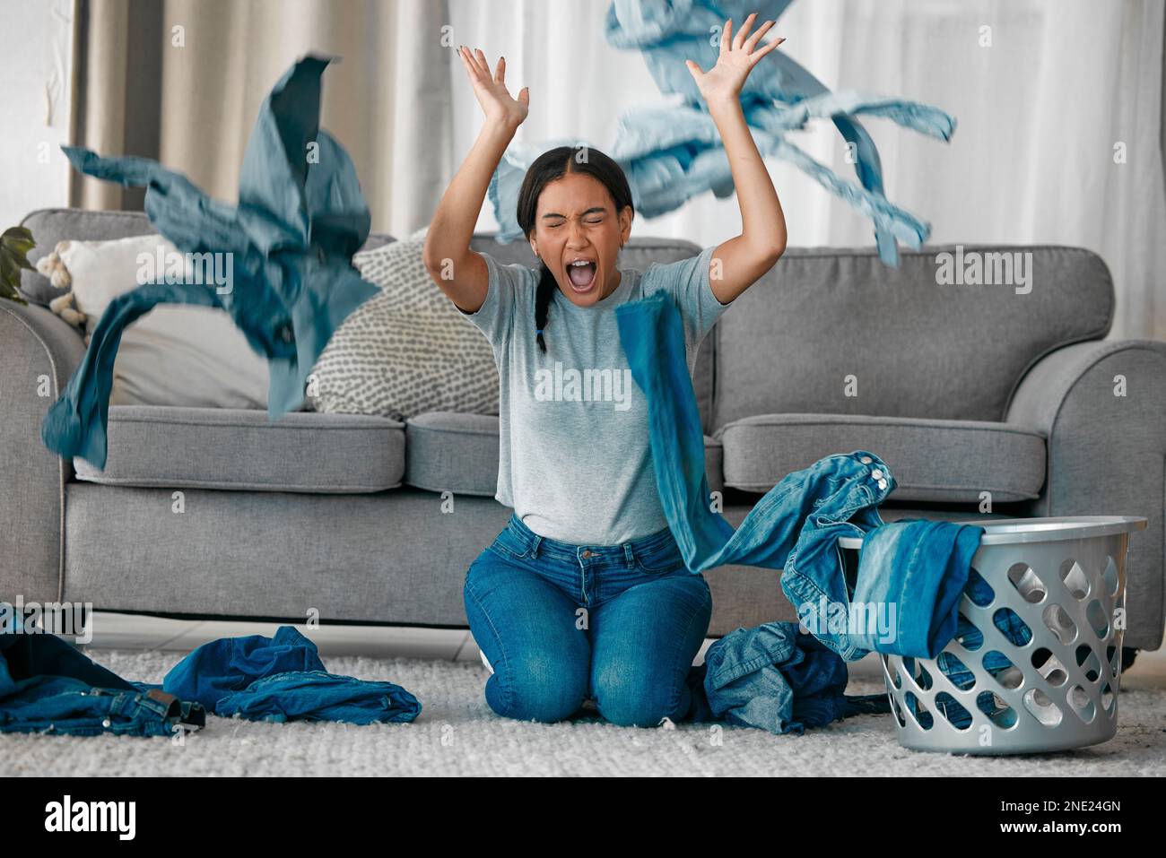 Laundry, angry and woman with clothes in air frustrated from cleaning ...