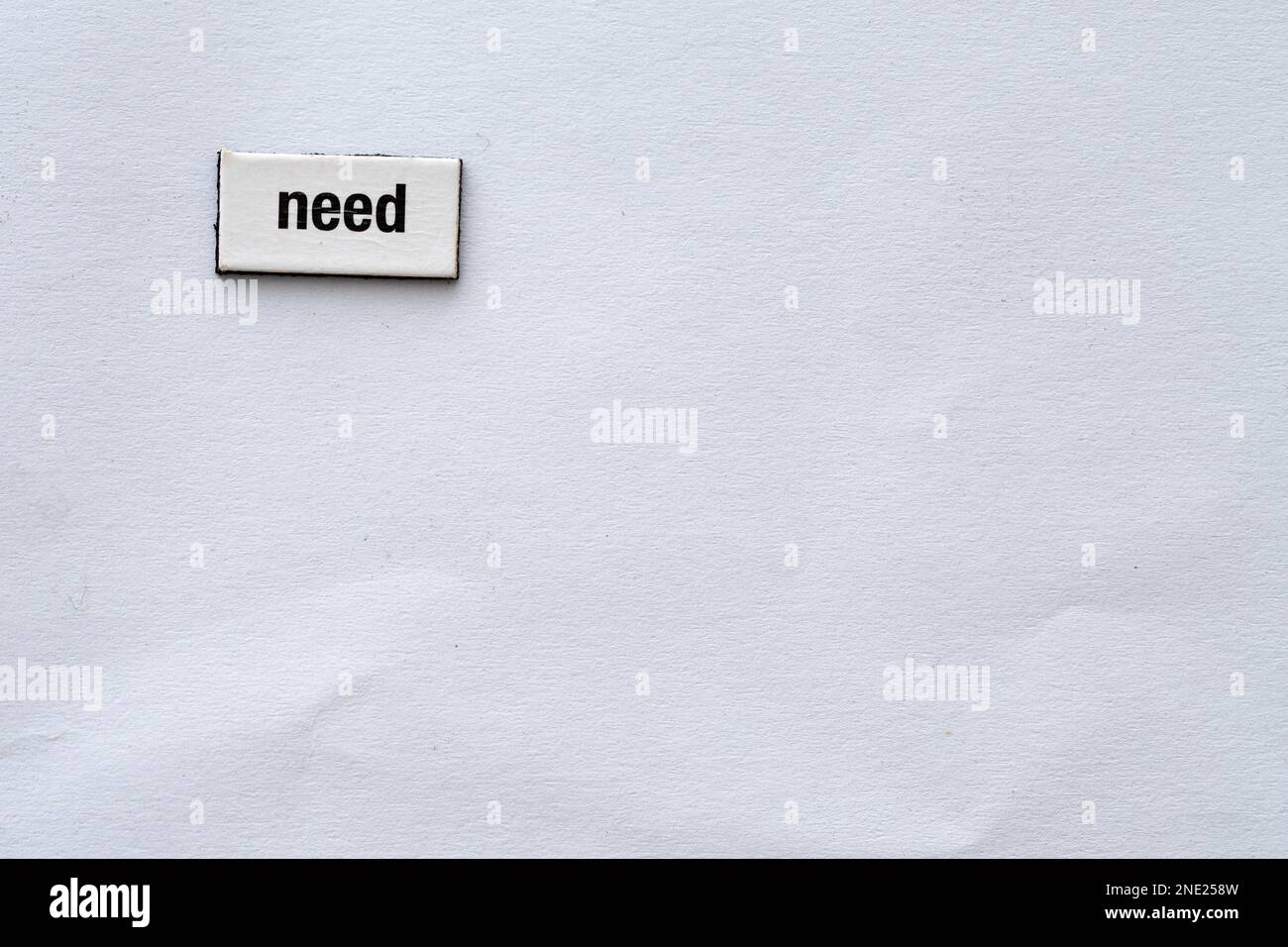 The word need on white background Stock Photo - Alamy
