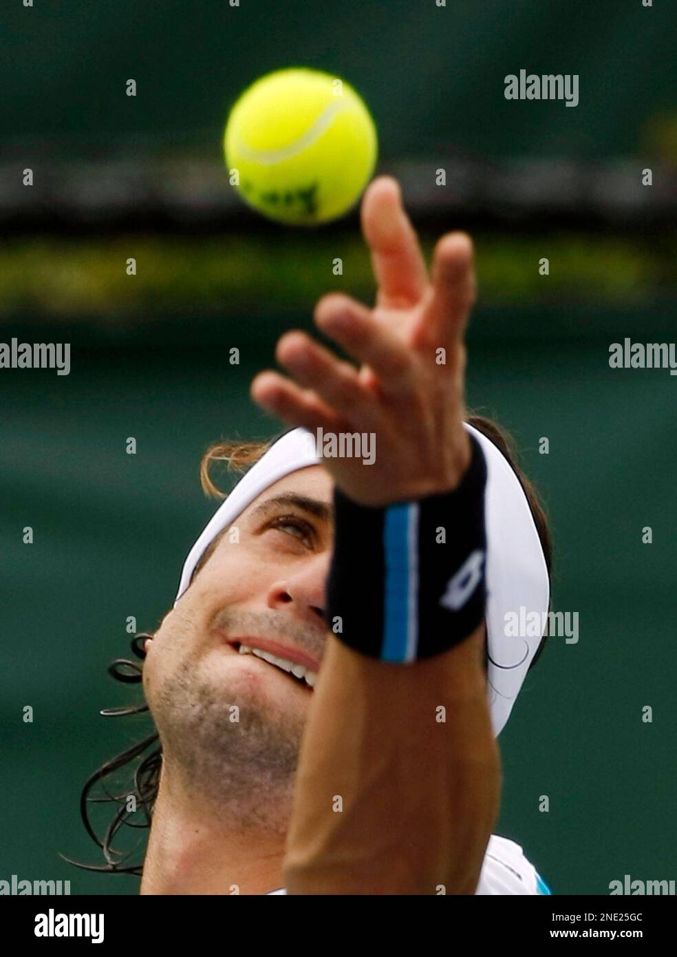 David Ferrer, of Spain, serves to Ivo Karlovic, of Croatia, during the ...