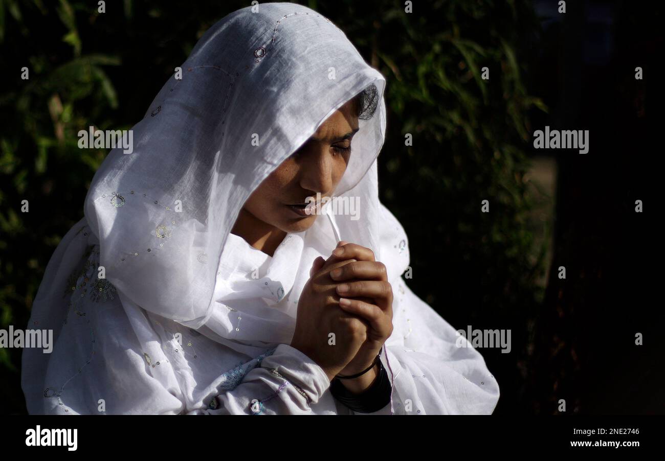 A Pakistani Christian woman prays during a mass on Orthodox Palm Sunday ...