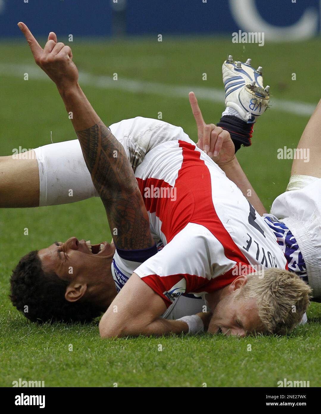 Samoa's Mikaele Pesamino, bottom, celebrate after scored as he is ...
