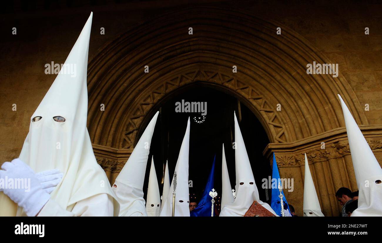 Penitents of the La Borriquita brotherhood take part in a Holy Week ...