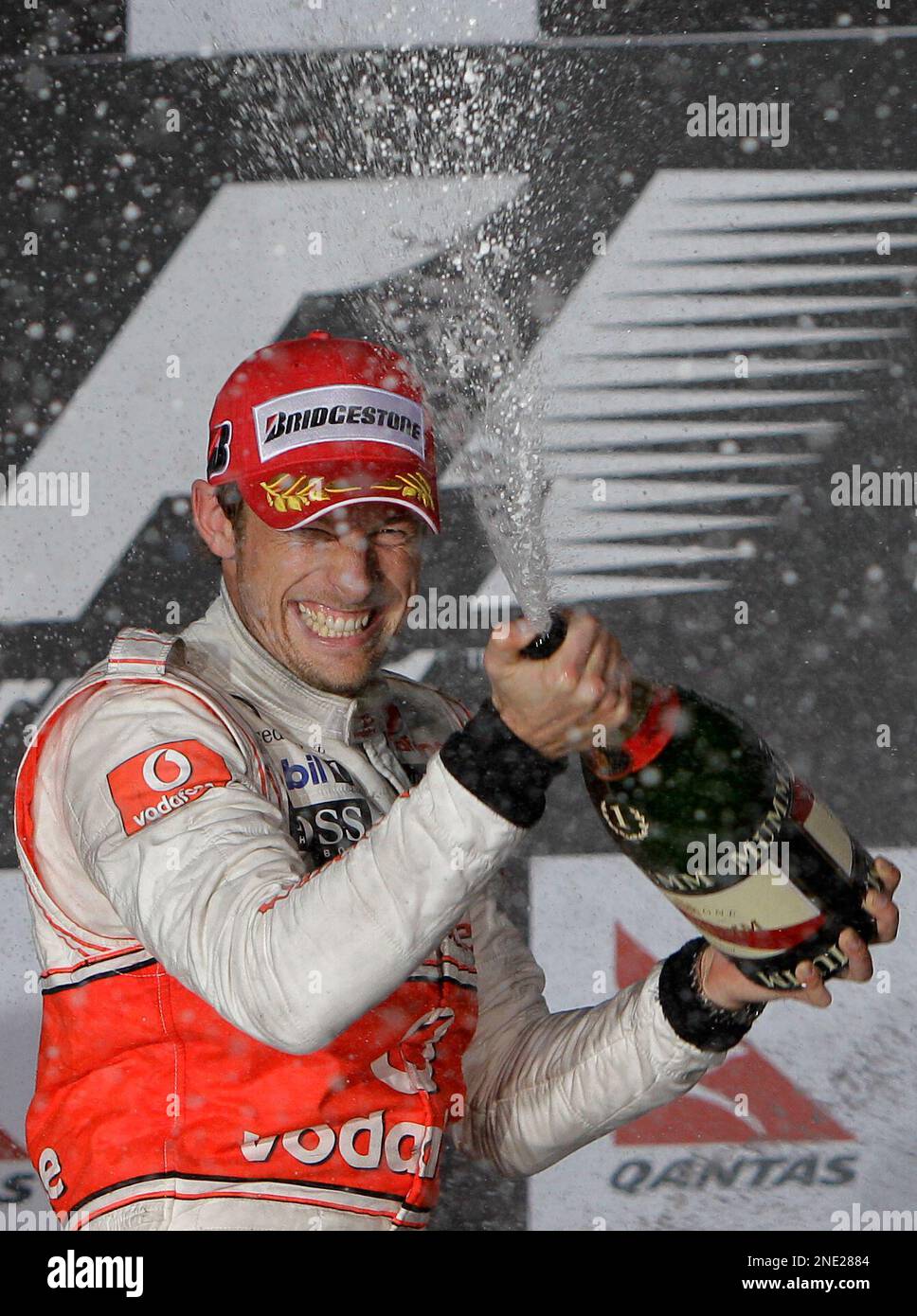 McLaren Formula One driver Jenson Button of Britain sprays champagne as ...
