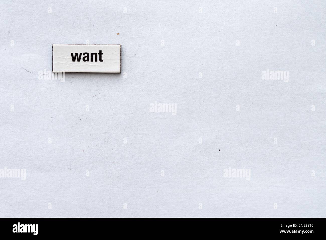 The word want on a white background fridge mag Stock Photo - Alamy
