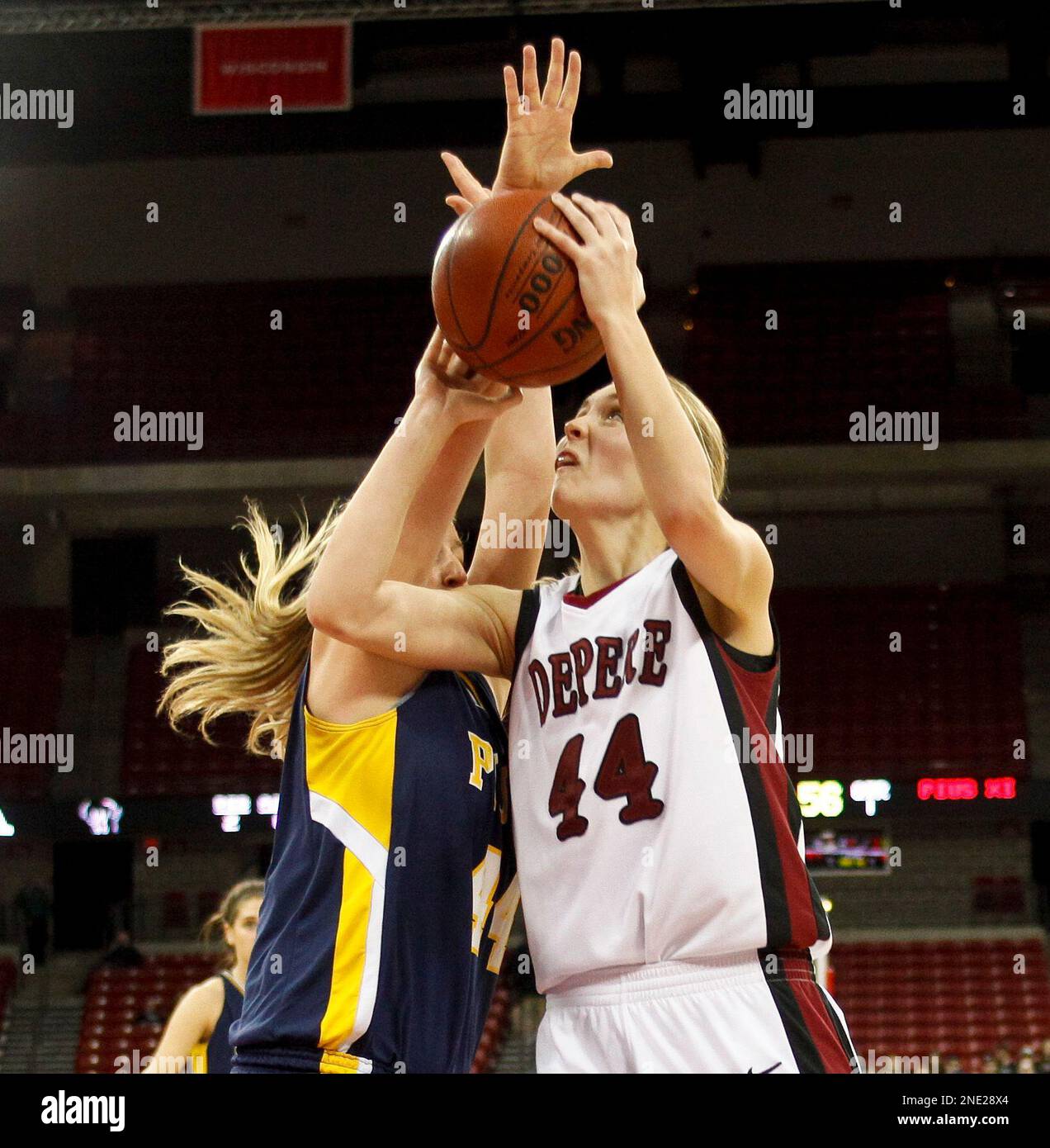 De Pere's Kristin Tischer (44) shoots against Milwaukee Pius' Kelly ...