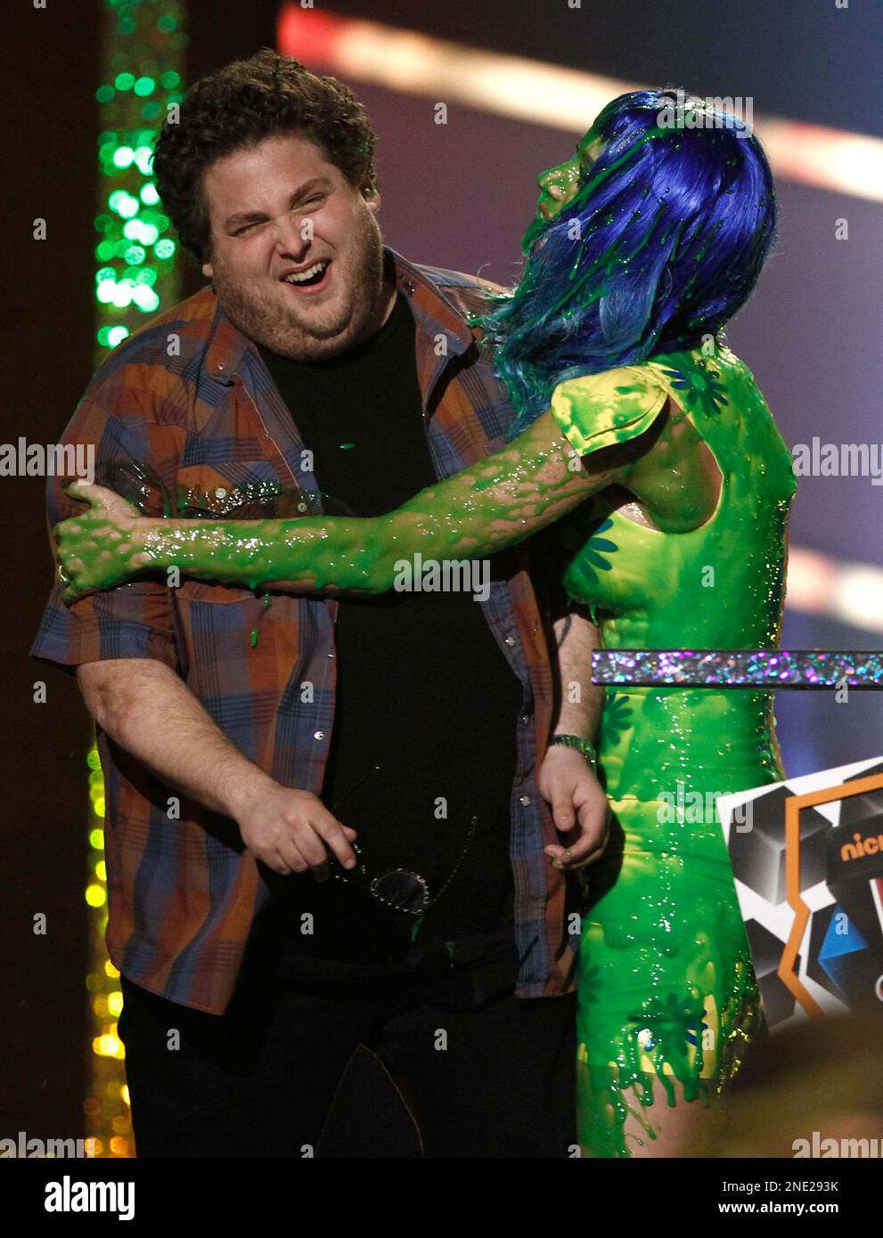 Jonah Hill, left, is hugged by Katy Perry after being slimed at ...
