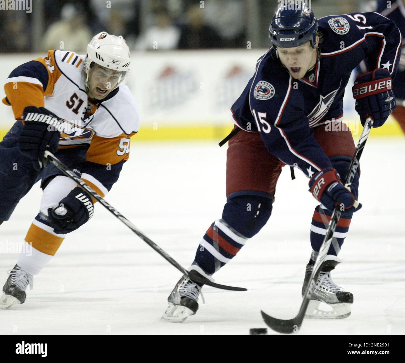 Columbus Blue Jackets' Derek Dorsett, right, moves the puck up the ice ...