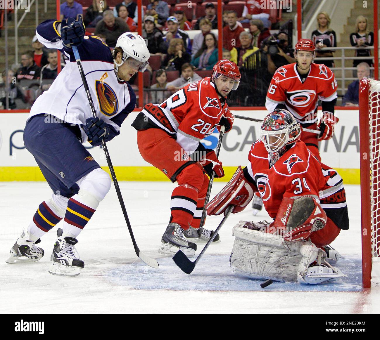 Carolina Hurricanes goalie Manny Legace (34) defends with Jamie McBain ...