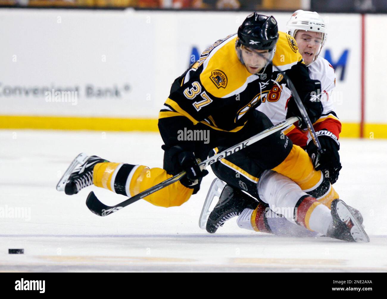 Boston Bruins' Patrice Bergeron (37) and Calgary Flames' Robyn Regehr ...