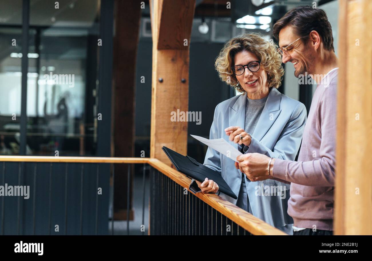 business people analysing a financial report together. Two business ...